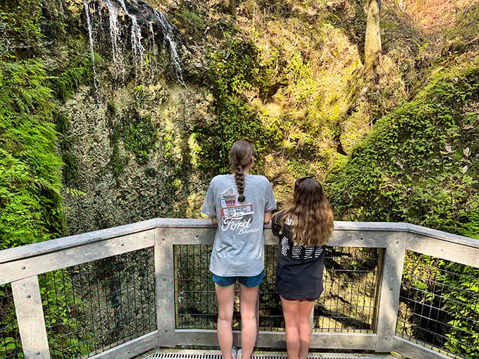 Two visitors mesmerized by nature's magic trick&mdash;now you see water, now you don't!