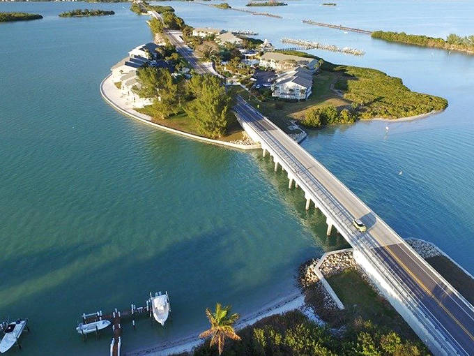 The Lemon Bay/Myakka Trail winds through Old Florida landscapes where Spanish moss-draped oaks create natural tunnels over the roadway.
