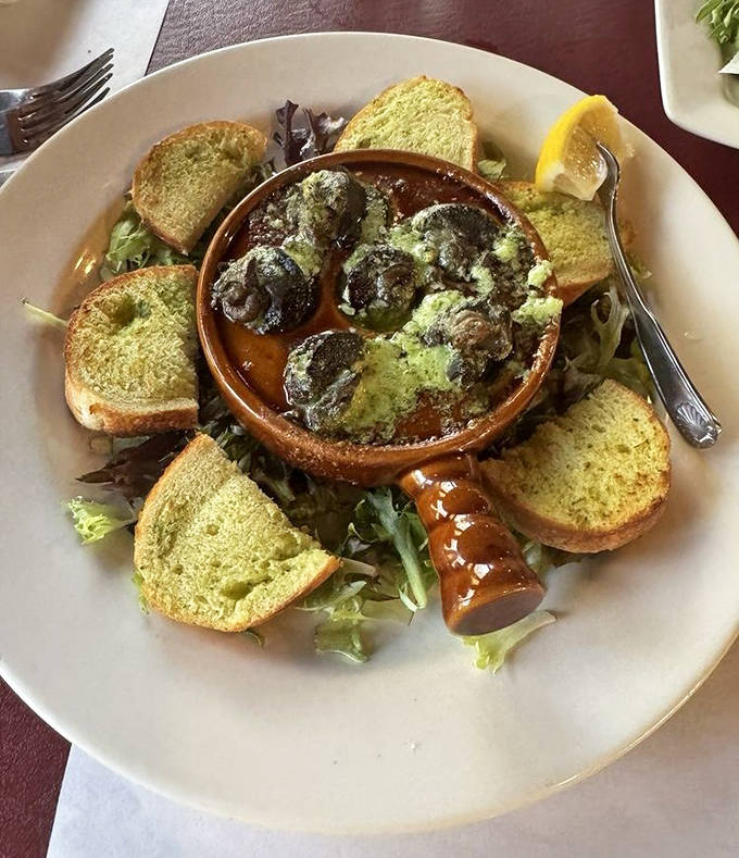 Escargots: These buttery morsels nestled in their ceramic home aren't just escargots &ndash; they're time travelers from a bygone era of continental dining.