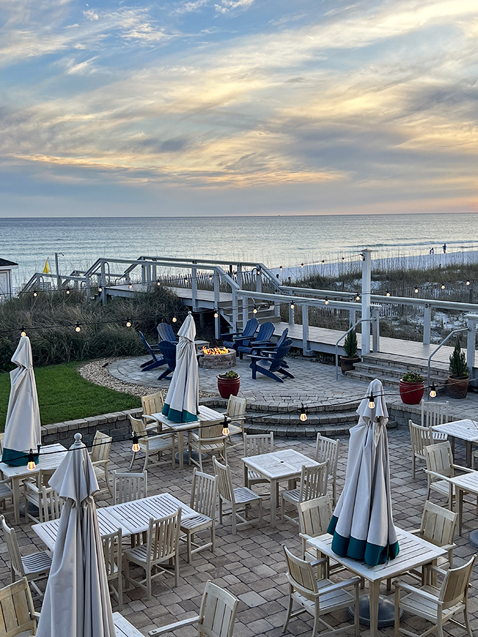 The oceanfront patio at Beach Walk restaurant provides a front-row seat to the Gulf's beauty, where dining tables and Adirondack chairs invite guests to linger.