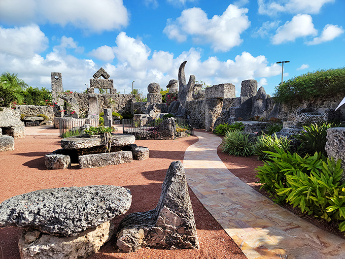 The pathways of Coral Castle wind through massive coral stone structures, each one hand-carved by a single man in a labor of love that continues to baffle engineers today.