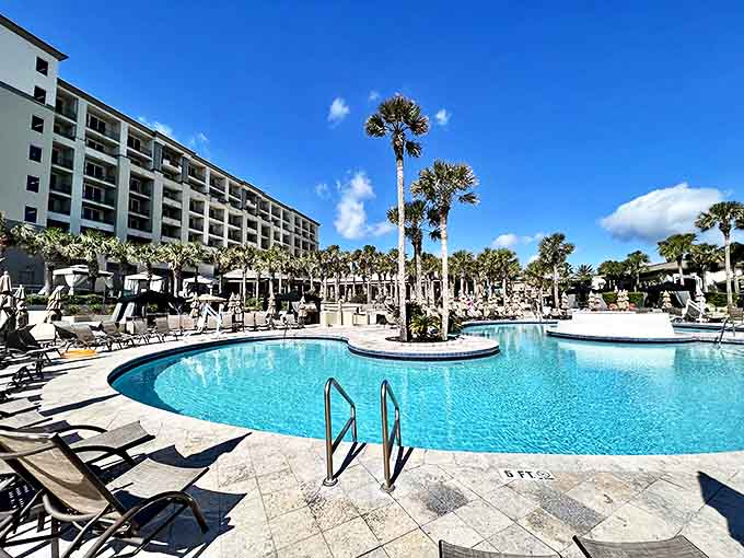 Palm-lined pools at the Ritz-Carlton Amelia Island offer refreshing escapes with plenty of lounging space for sun-seeking couples.