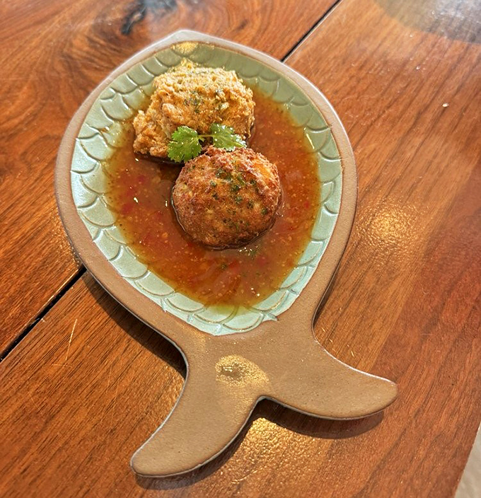 These crab cakes contain so much actual crab, they should come with their own fishing license. That tomato broth adds just enough acidity to cut through the richness.