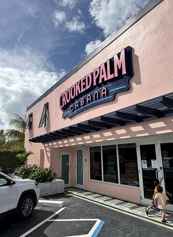 The Crooked Palm Cabana's pink fa&ccedil;ade stands out like a tropical sunset, inviting hungry travelers to sample their fresh Florida fare.
