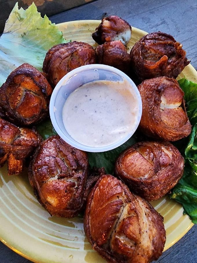 Indulge in these savory bacon-wrapped scallops at Grills Seafood Deck & Tiki Bar for the perfect Cape Canaveral treat.