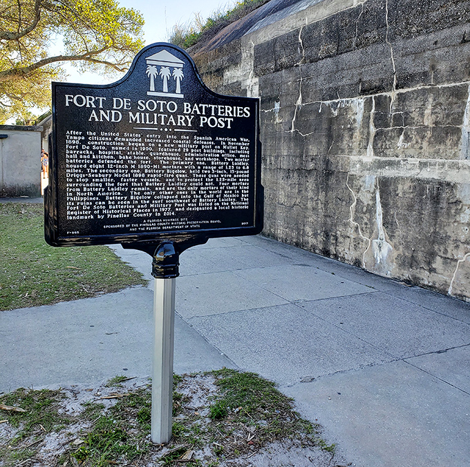Historical information: This weathered plaque tells tales of soldiers and strategies, standing sentinel beside walls that have witnessed a century of Florida history.