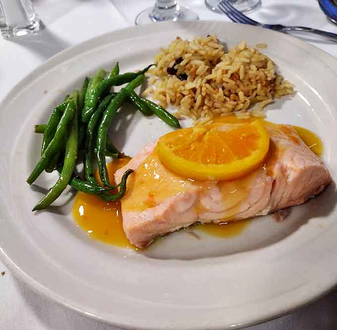 Perfectly cooked salmon takes center stage, flanked by colorful vegetable companions that prove supporting acts can be just as memorable.