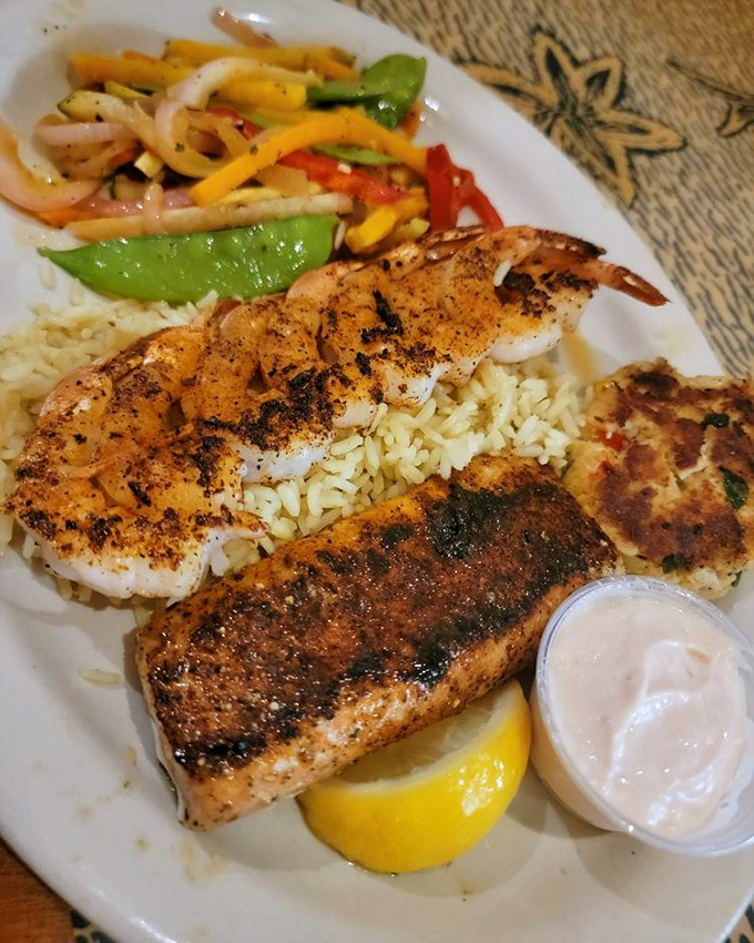 The seafood combo plate showcases Shells' grilling expertise &ndash; perfectly charred shrimp and fish atop fluffy rice with colorful vegetables dancing alongside.