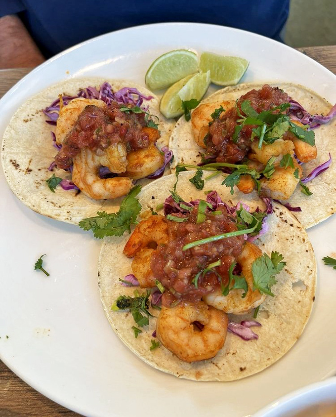 These shrimp tacos aren't just food, they're tiny flavor festivals &ndash; each bite delivers a perfect balance of seafood, spice, and tropical zing.
