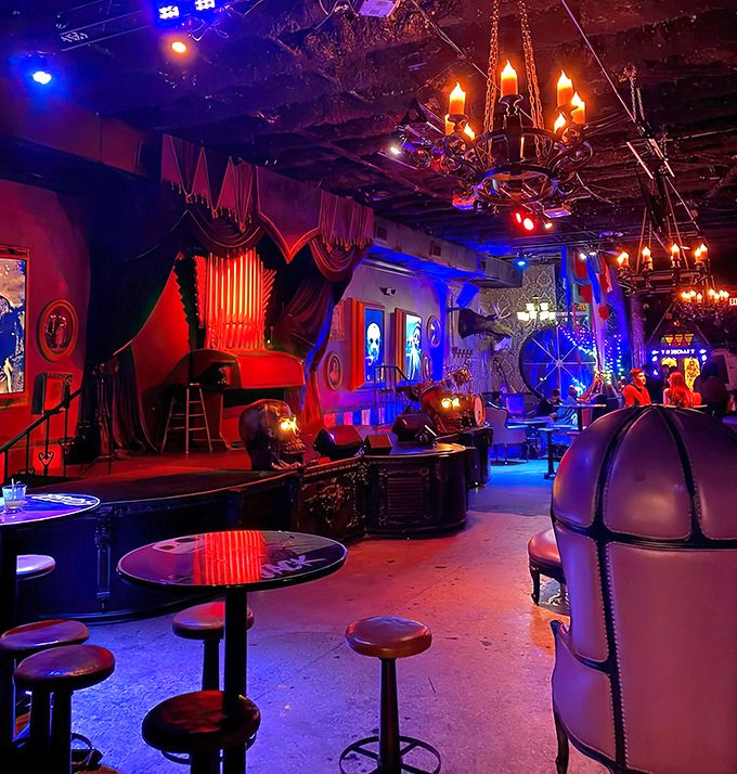 The stage area features vintage-inspired curtains and gothic elements, hosting everything from horror trivia nights to live performances.