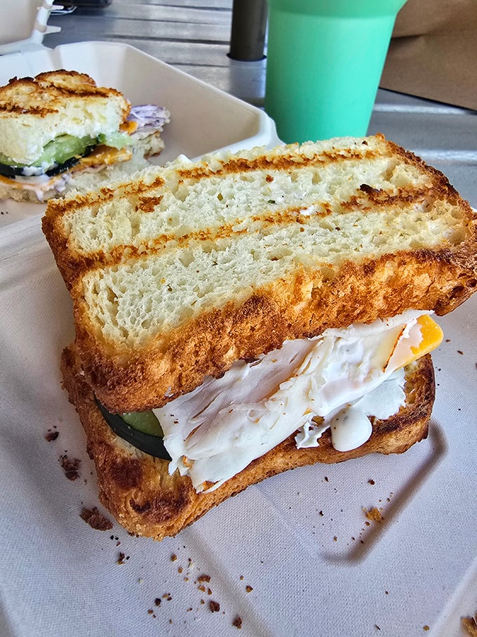 Golden-brown toast revealing layers of creamy filling and fresh cucumber &ndash; comfort food elevated to an art form.