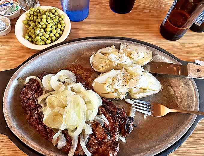 Steak, baked potatoes and peas: Comfort food elevated to art form. Those caramelized onions aren't just a topping&mdash;they're a flavor revelation.