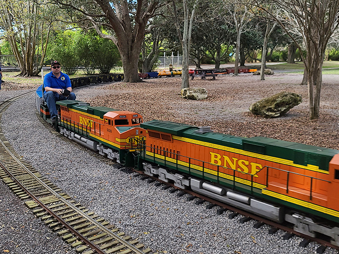 The BNSF diesel locomotive pulls its human cargo with precision &ndash; these aren't toys, they're engineering marvels in miniature.