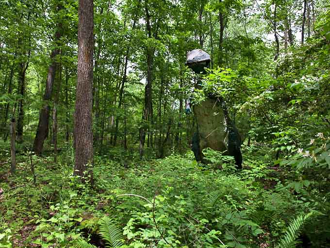 The lush greenery now embraces these prehistoric sculptures, nature slowly reclaiming what man created.