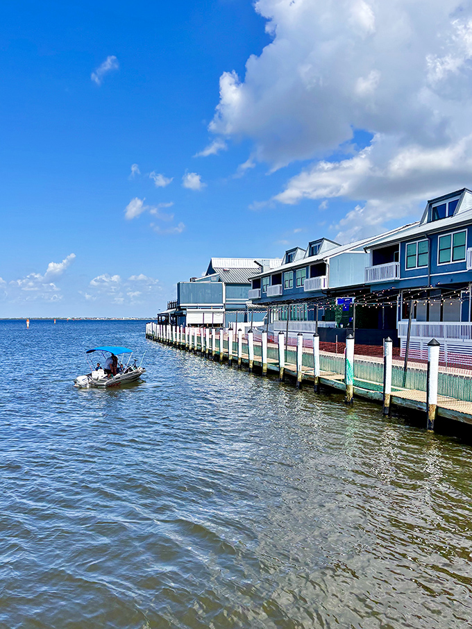 Waterfront establishments line the harbor like a welcoming committee, their reflections dancing on the water's surface with each passing boat wake.