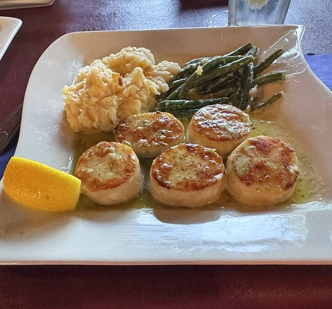 Scallops: Perfectly seared scallops glisten like pearls against green asparagus spears &ndash; ocean candy that would make even the most hardened gangster smile.