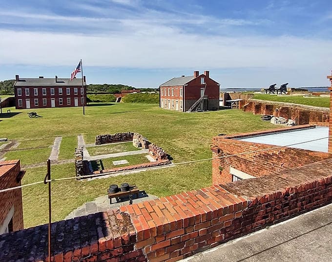 Historic brick fort walls and cannons stand ready, frozen in time from Civil War days long past.