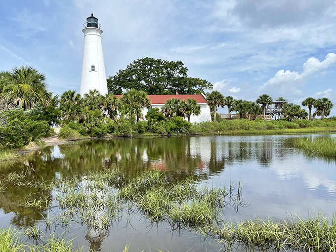 St. Marks Lighthouse stands tall against the coastal landscape, its white tower a beacon that has guided mariners along Florida's Gulf Coast since 1842.