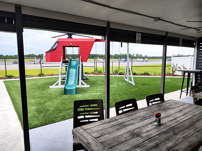 The outdoor dining area at Highjackers Restaurant offers front-row seats to the runway action, where small planes become part of the mealtime entertainment.