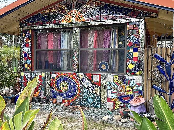 Whimzeyland's exterior explodes with vibrant mosaic patterns, turning an ordinary house into an extraordinary artistic statement.
