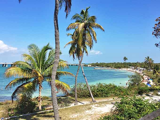 The old bridge creates a dramatic backdrop for this pristine Keys beach with its turquoise water.