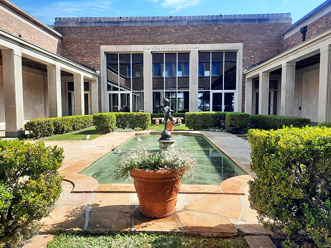 A serene reflecting pool in the Cummer Museum's formal gardens creates a peaceful retreat along the St. Johns River.