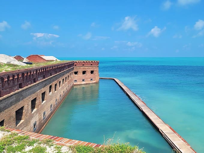 The fort's moat fills with water so clear and blue it looks like someone poured liquid sapphire around the walls.