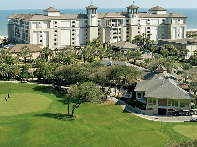 A coastal kingdom with palm trees standing guard. The perfect blend of beachfront bliss and architectural elegance awaits just beyond that wooden walkway.
