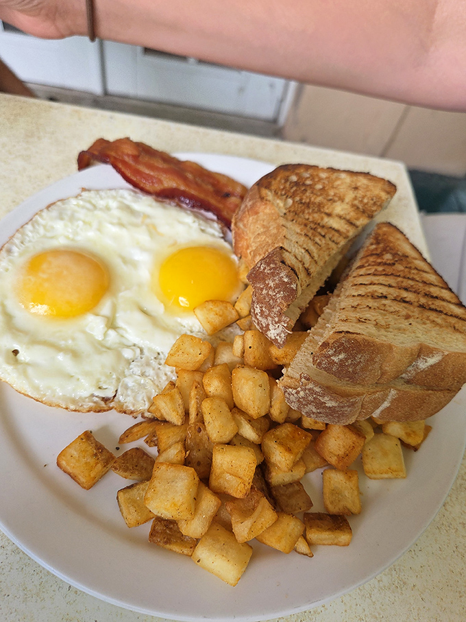 Breakfast perfection on a plate &ndash; sunny eggs, golden potatoes, and toast that makes you appreciate the simple things done extraordinarily well.