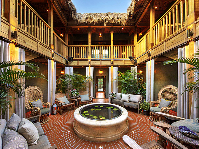 In this courtyard lounge, even the plants seem to be on vacation, lounging with tropical nonchalance around the water feature.