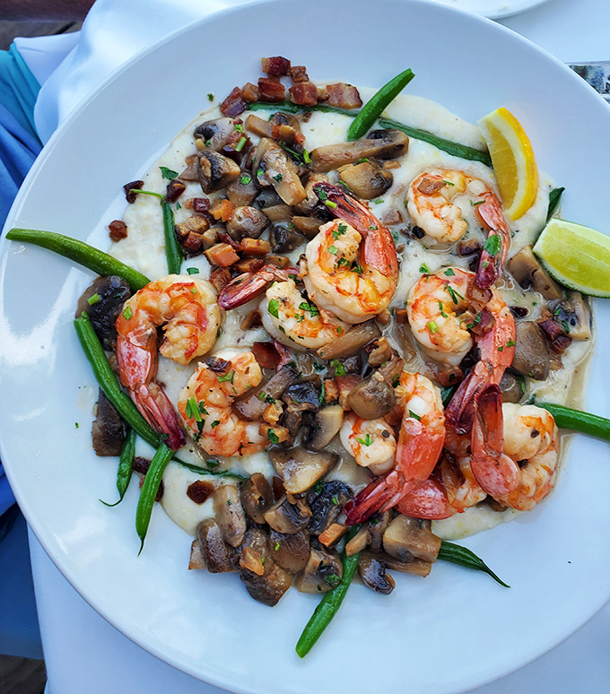 These shrimp look like they just had a spa day before lounging on their bed of creamy grits. Comfort food that went to finishing school.