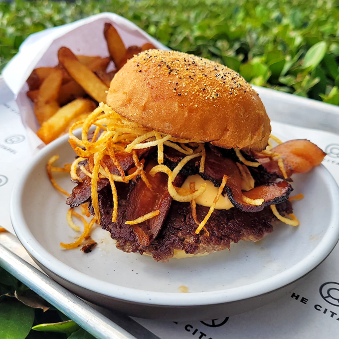 The Squab Game Burger topped with crispy fried onions &ndash; a tower of flavor that makes waiting for delivery absolutely worth it.