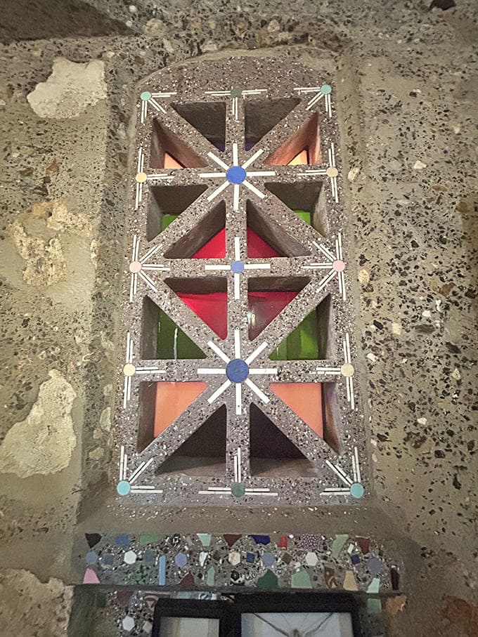 Geometric patterns in colored glass and stone create windows that are less about looking through and more about looking at, which seems perfectly appropriate here.