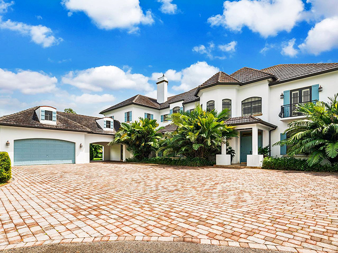 Mediterranean elegance meets Florida charm in this sprawling villa that practically whispers "yes, you DO deserve this" with every pristine corner.