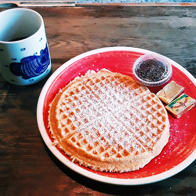 A perfectly executed waffle dusted with powdered sugar &ndash; simple pleasures done right, the way breakfast should always be.