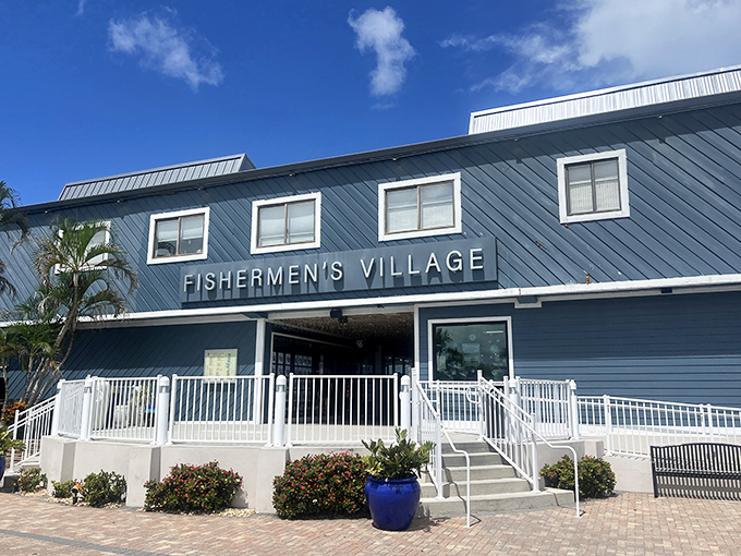 The grand entrance to Fishermen's Village stands proudly in coastal blue, promising retail adventures with a side of pelican watching.