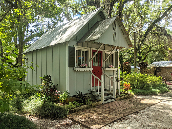 This mint-green cottage looks like it was plucked straight from a fairy tale, its cheerful color and flower boxes adding whimsical charm to the gardens.