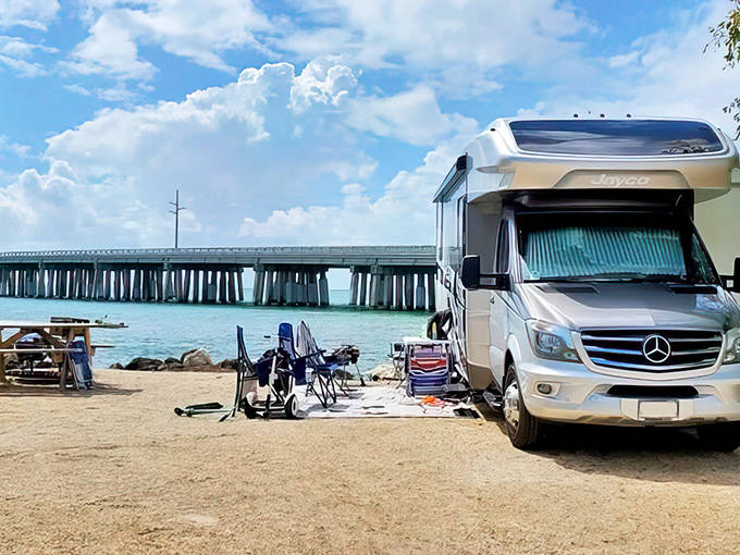 An RV parked at Bahia Honda State Park with the Seven Mile Bridge visible in the distance, showcasing the Keys' unique camping experience.
