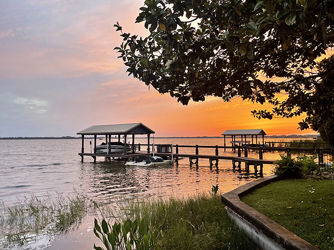 Lake Dora's wooden docks extend like welcoming arms into waters that catch fire with color during the lake's famously spectacular sunsets.