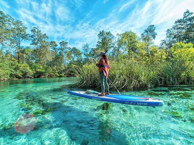 Crystal-clear water reveals every detail below the surface, making paddleboarding feel like floating on glass.