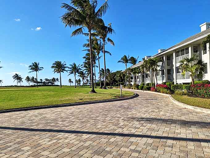 Pristine grounds at South Seas Island Resort lead to waterfront accommodations, with palm trees framing views of the Gulf.