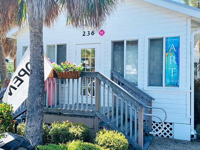 The Art Center's charming white cottage houses local creativity, with colorful banners announcing exhibits that capture Gasparilla Island's unique light and landscape.