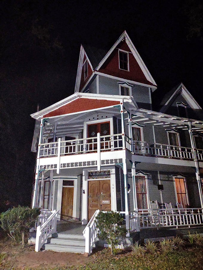 After dark, the May-Stringer House transforms, its illuminated windows like eyes watching visitors approach for evening ghost tours.