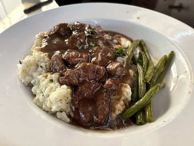 Comfort food elevated &ndash; tender beef tips nestle against creamy risotto with green beans standing at attention, ready for their delicious duty.
