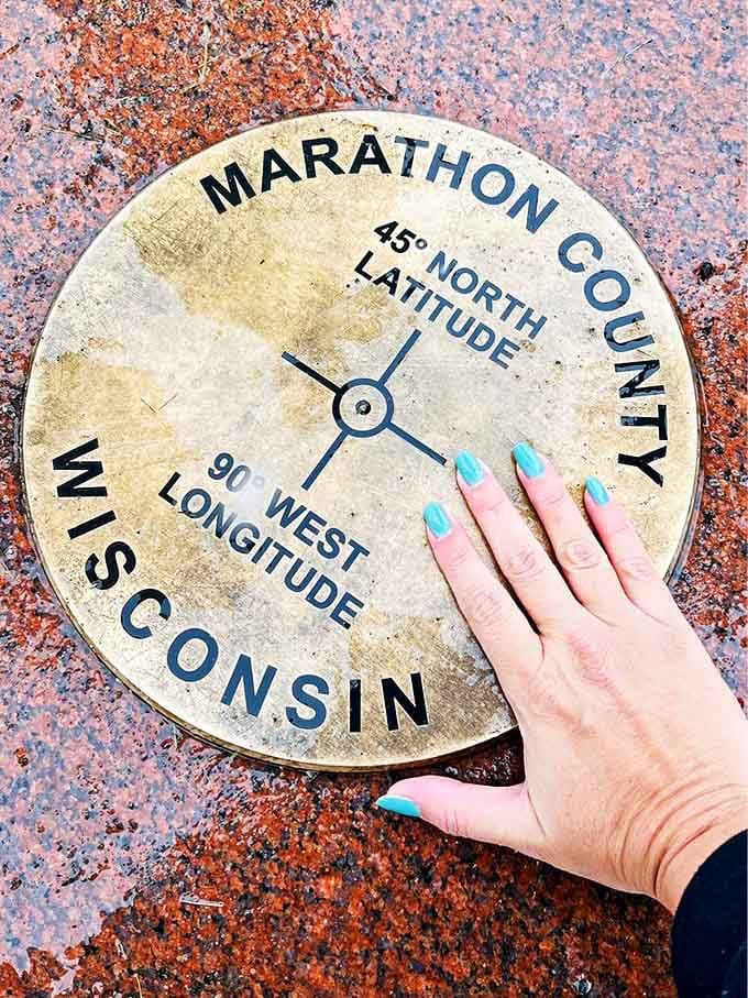 The commemorative marker becomes a tactile connection to global navigation systems created long before GPS existed.