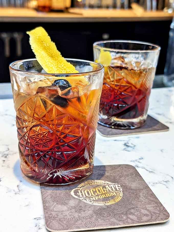 These aren't ordinary Negronis&mdash;they're served in vintage-inspired crystal glasses that catch the light like liquid amber jewels from another era.