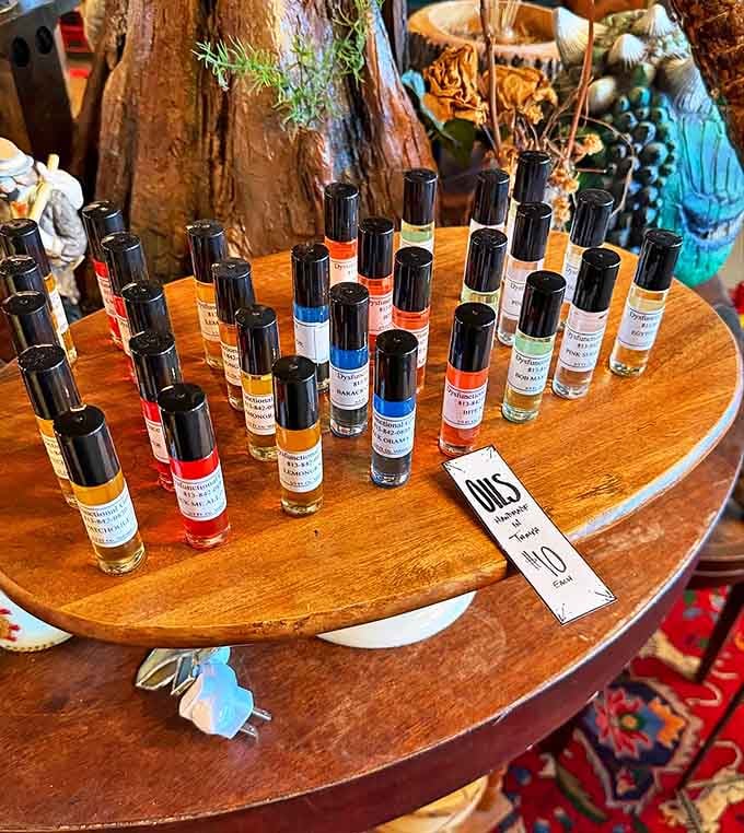 Tiny bottles of olfactory magic line this display, each hand-blended essential oil promising to transport you from "Midnight Garden" to "Witch's Brew."
