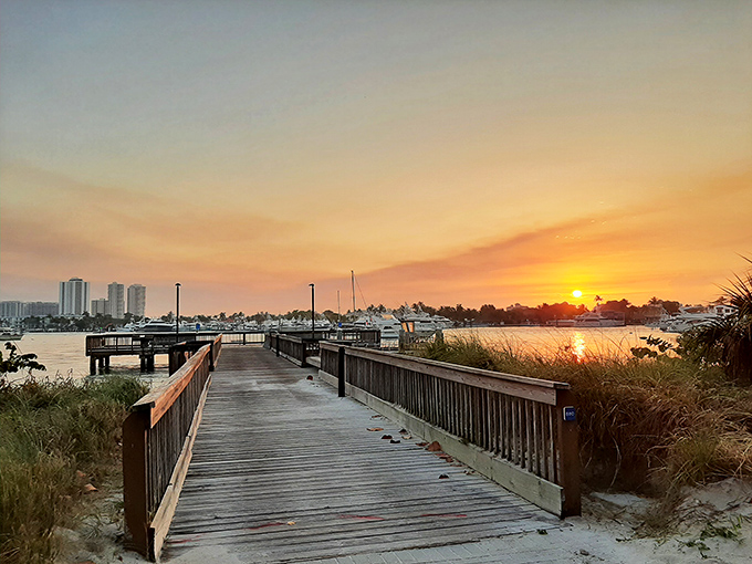 Twilight paints the sky in watercolor hues as day visitors depart, leaving behind footprints that will vanish with the tide and memories that won't.