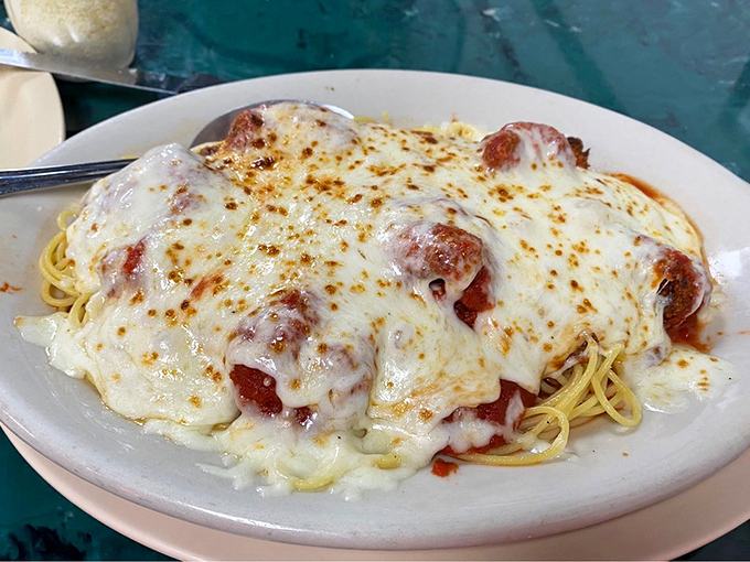 Plump shrimp nestled under a molten cheese canopy with spaghetti standing by&mdash;seafood and pasta in perfect harmony.