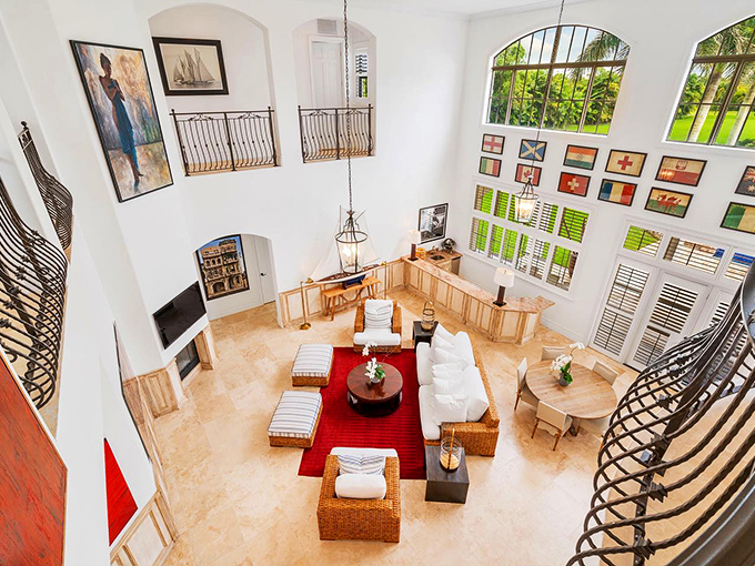 Soaring ceilings and thoughtful design create living spaces where conversations flow as easily as the natural light pouring through those generous windows.